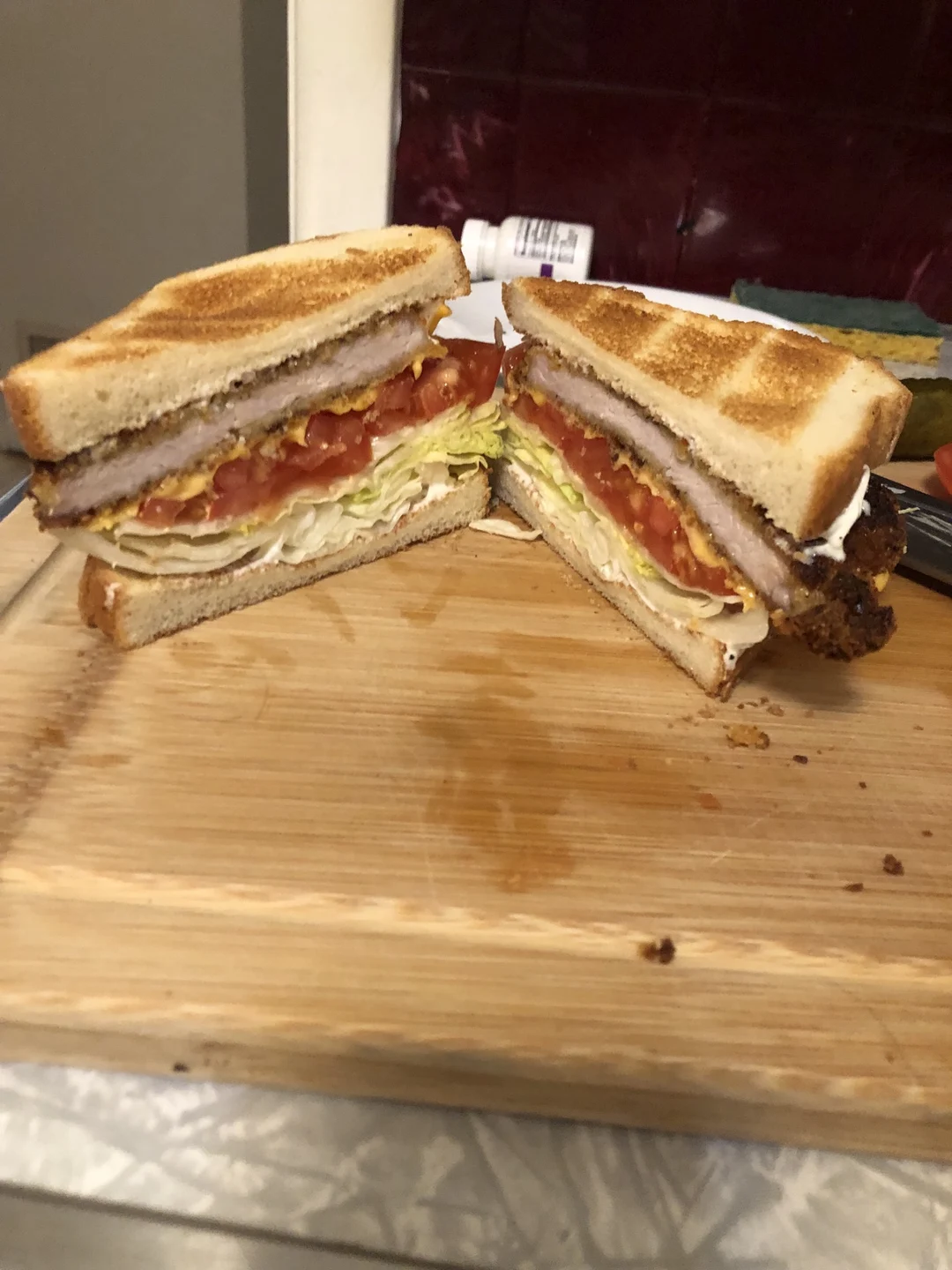 Pork Katsu on potato bread with tomato iceberg mayo and American cheese. | Scrolller