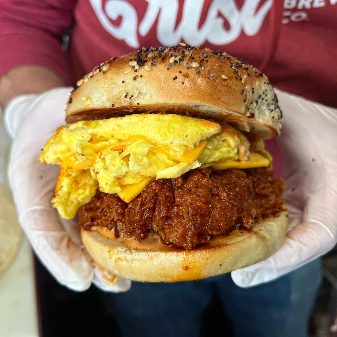 Bagel with hot chicken, chipotle sauced egg, cheese. | Scrolller