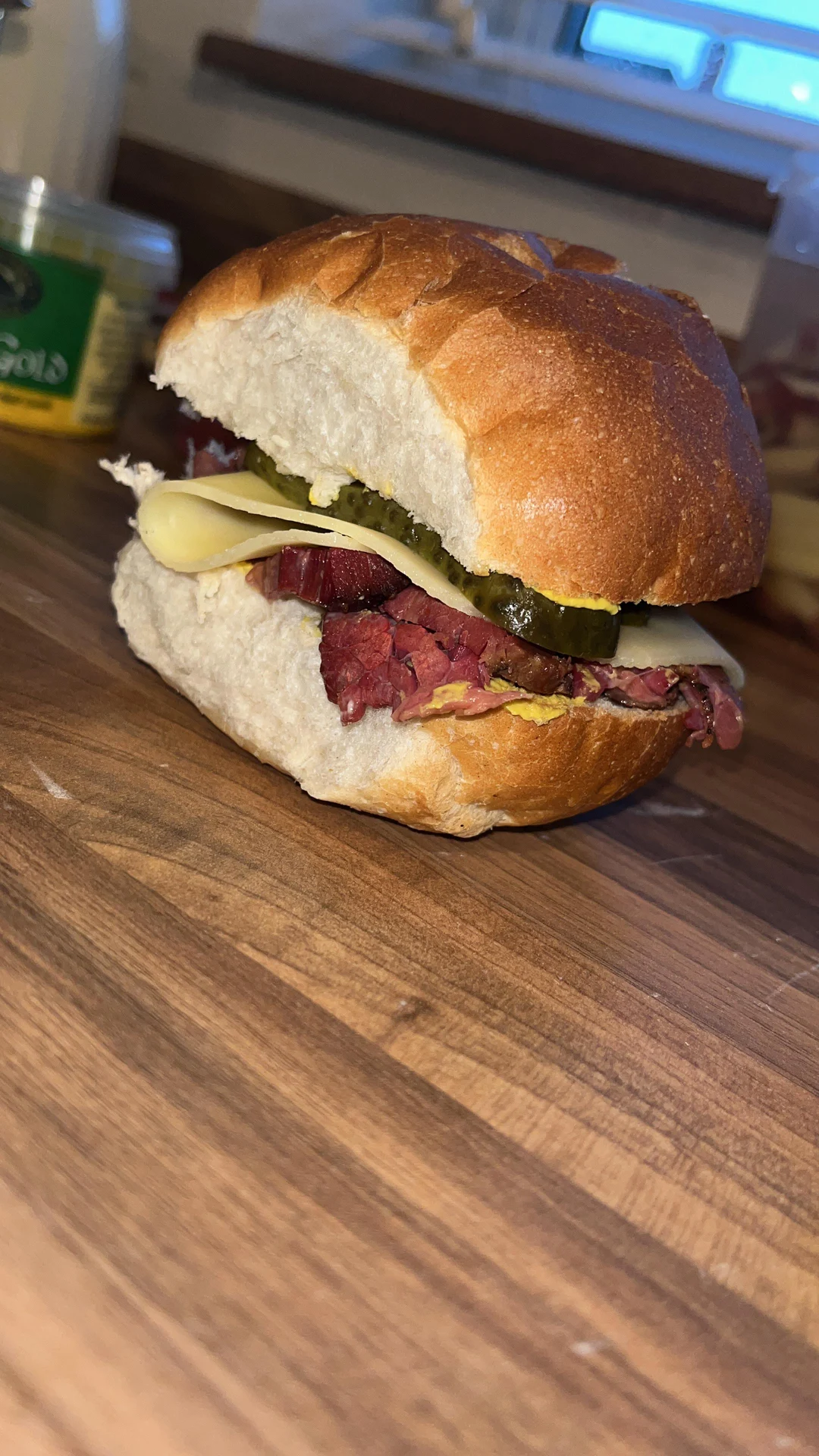 Pastrami,swiss cheese pickles and mustard on a crusty roll | Scrolller
