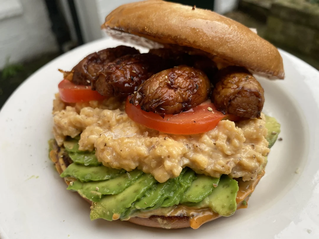 Breakfast bagel sandwich with sausage, tomato, soft scramble, avocado and Gochujang mayo | Scrolller