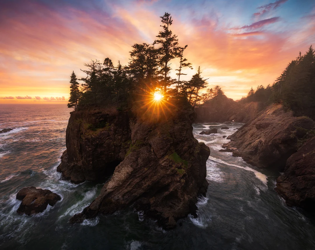 Sun setting behind a tree covered sea stack on the Oregon Coast [2000x1586][OC] | Scrolller