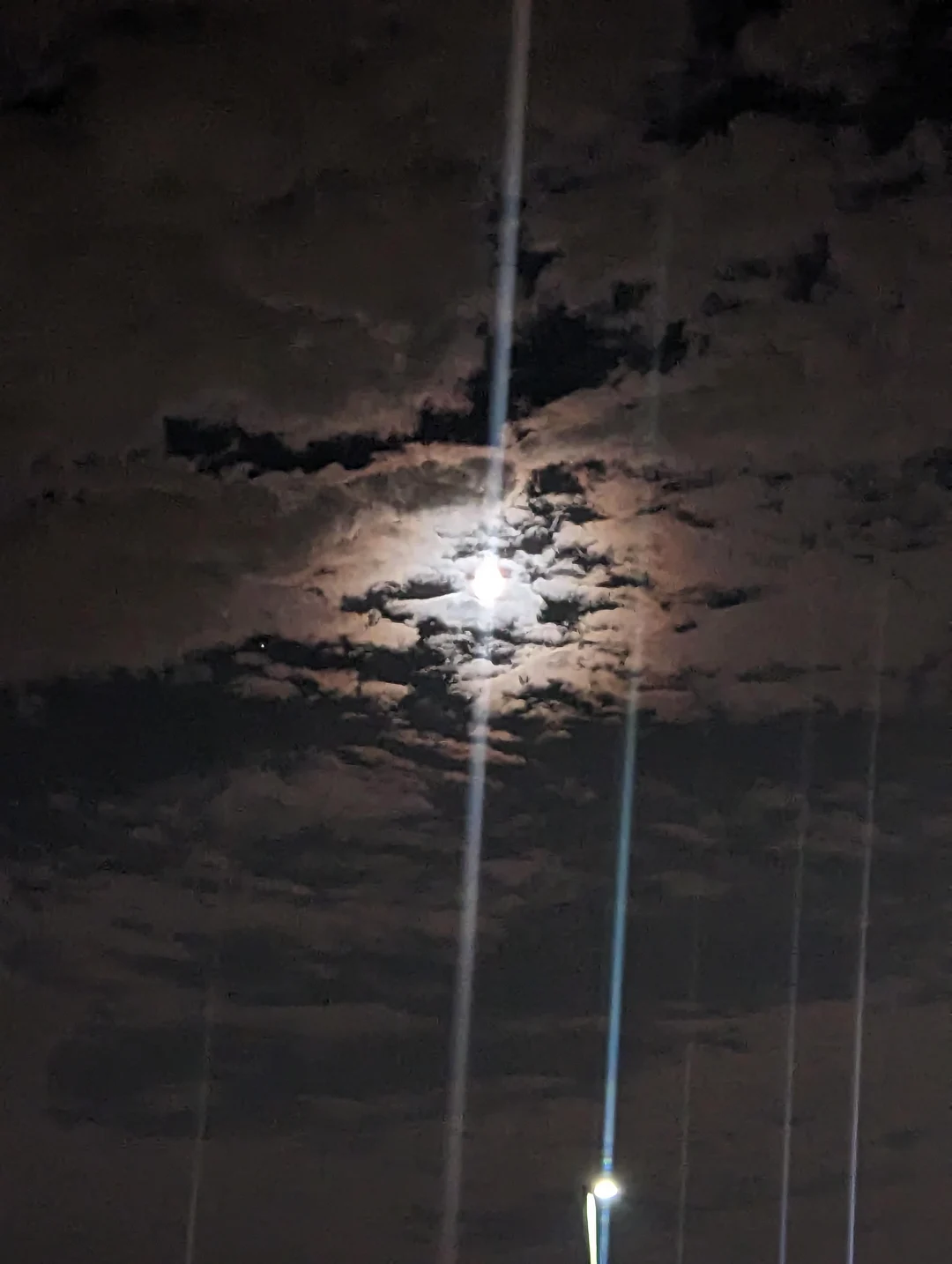 Moon shining through clouds | Scrolller