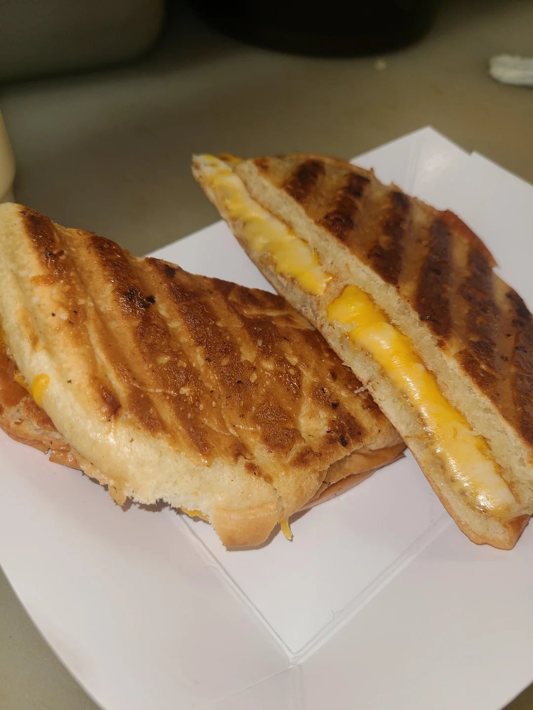 Grilled Cheese with cheddar, American, and pepperjack on a grilled bun. | Scrolller