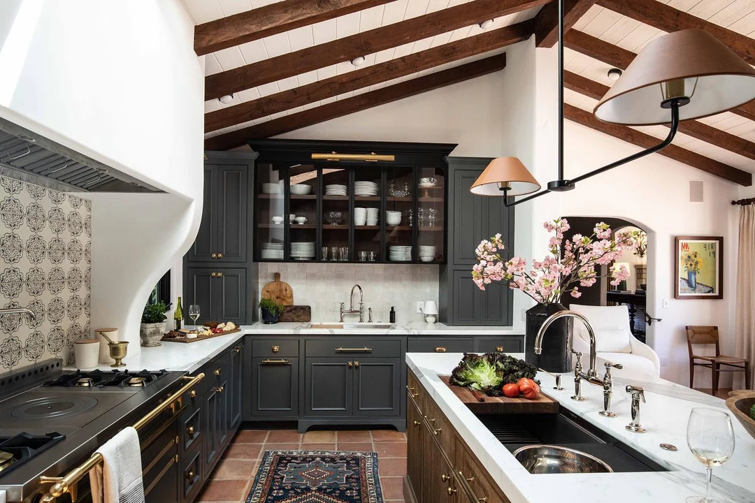 Wood-beamed vaulted ceiling kitchen with terracotta tile floors in a Spanish-style house, Carmel ...