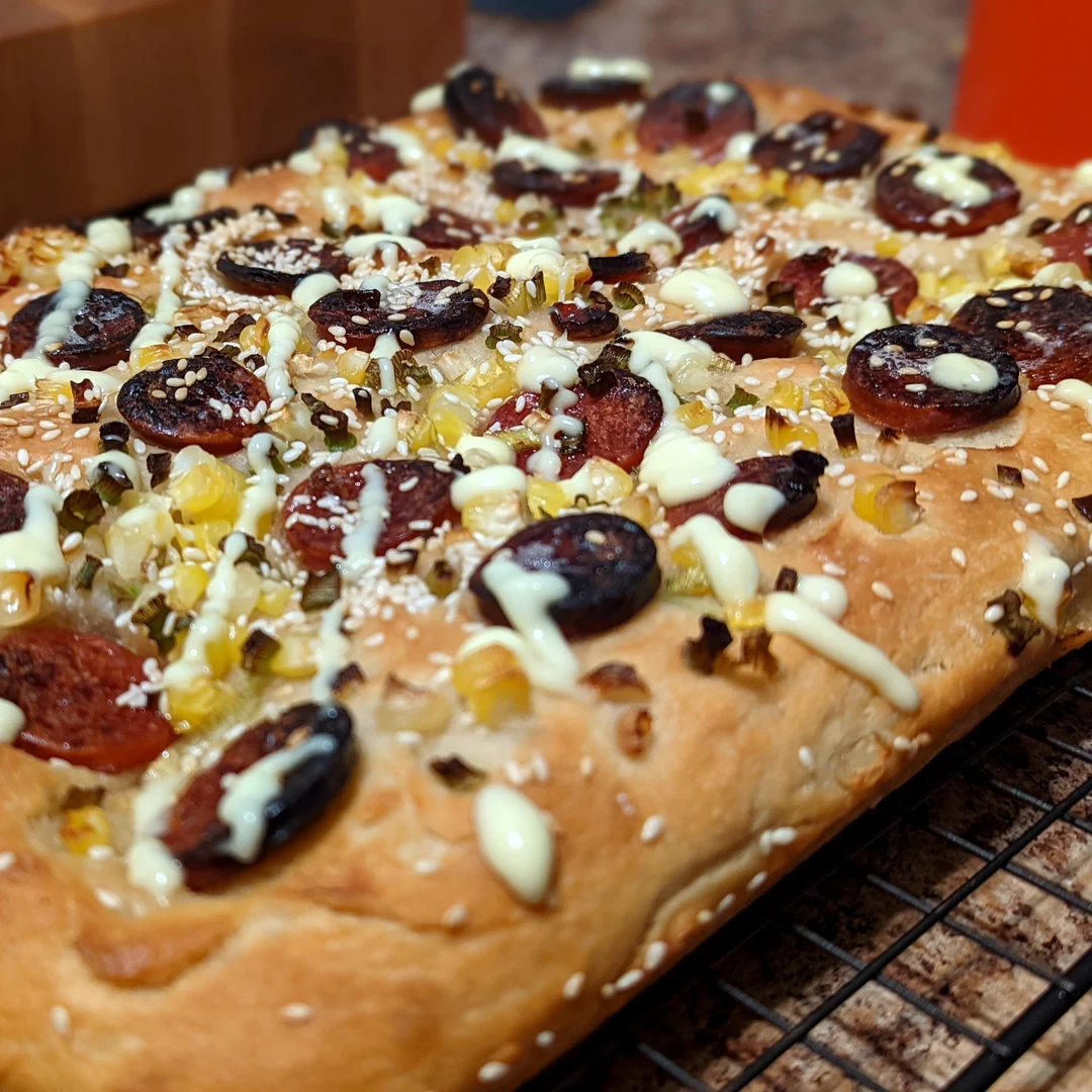 Taiwanese-style focaccia with corn, chinese sausage, sesame seeds, scallions, and kewpie mayo ...