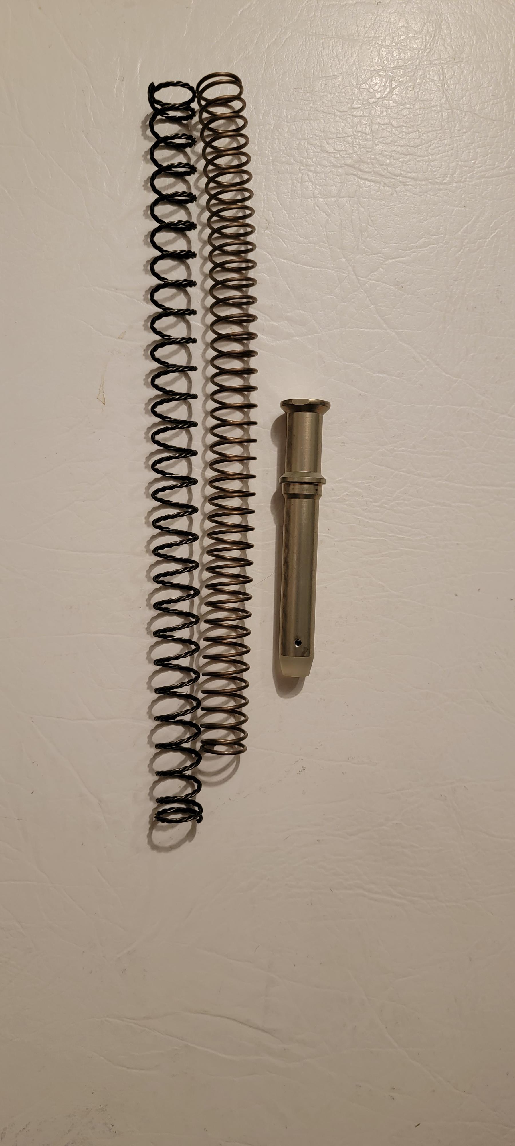 Discover more like AR10: The spring on the right came with the Areo rifle length M5(.308) buffer ...