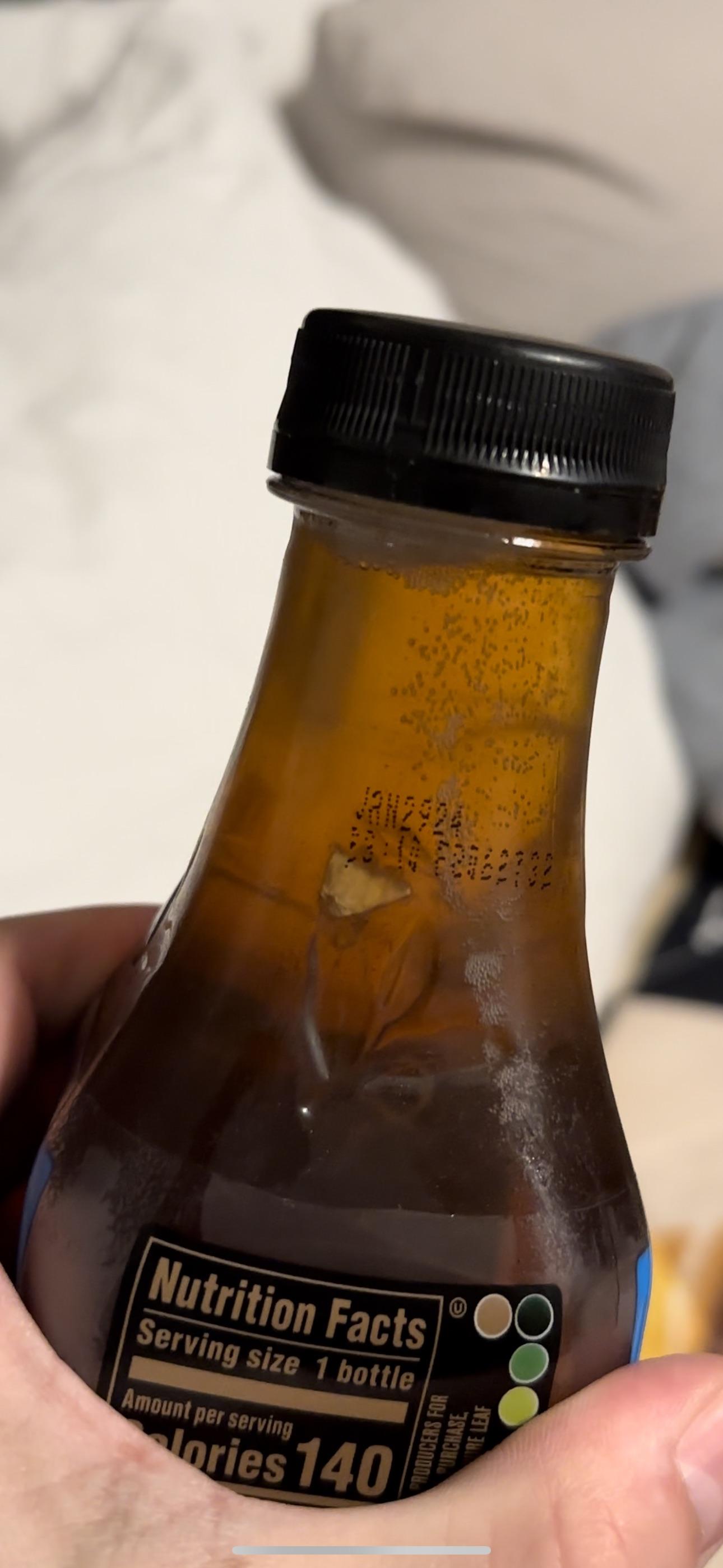 Weird floating stuff inside unopened pure leaf bottle. | Scrolller