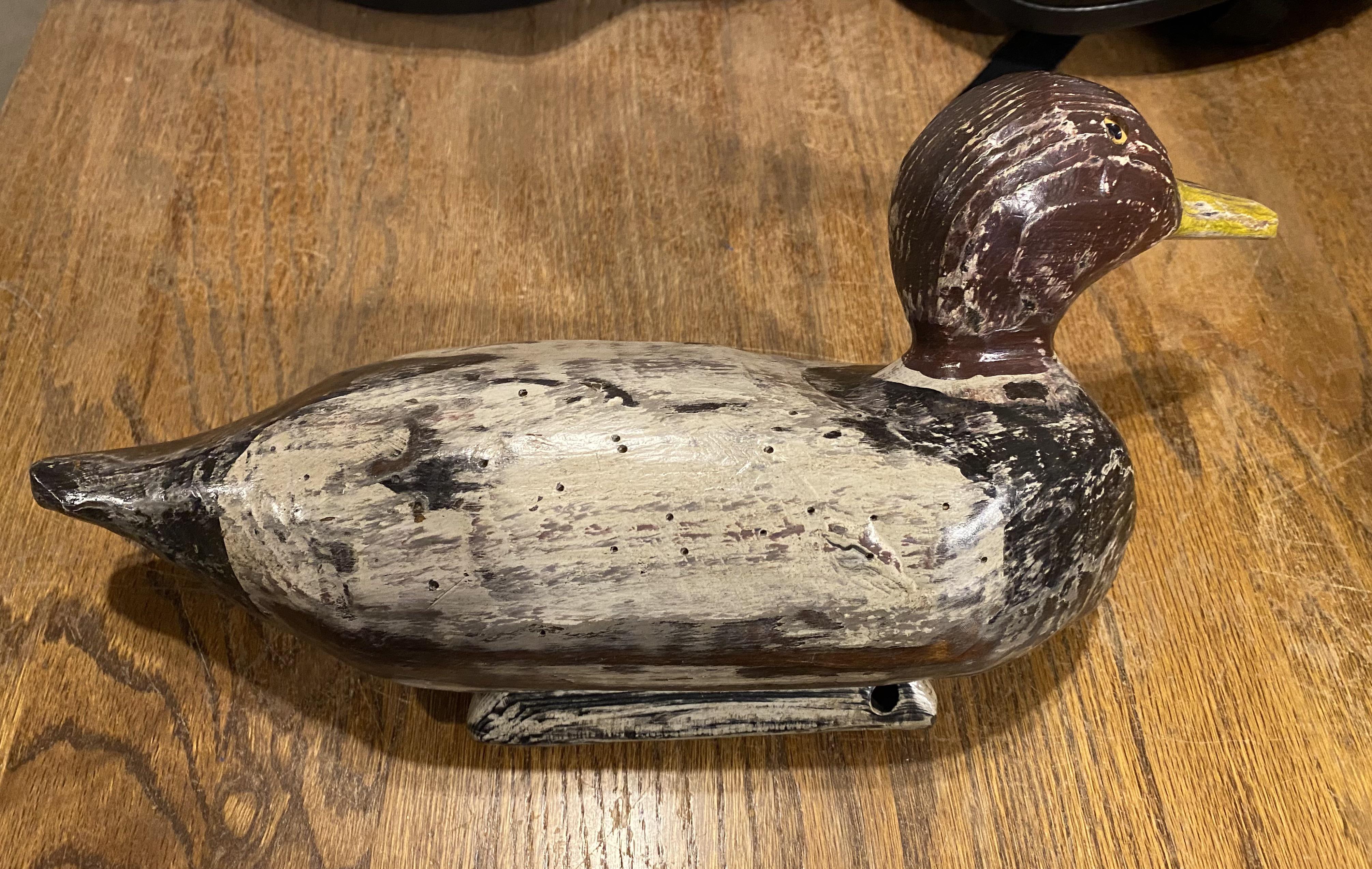 Any idea the name is on this wooden duck decoy? | Scrolller