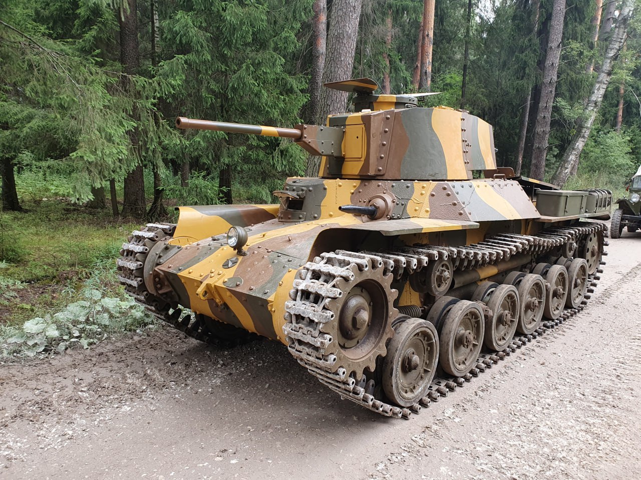 Column of museum equipment on a forest road | Scrolller