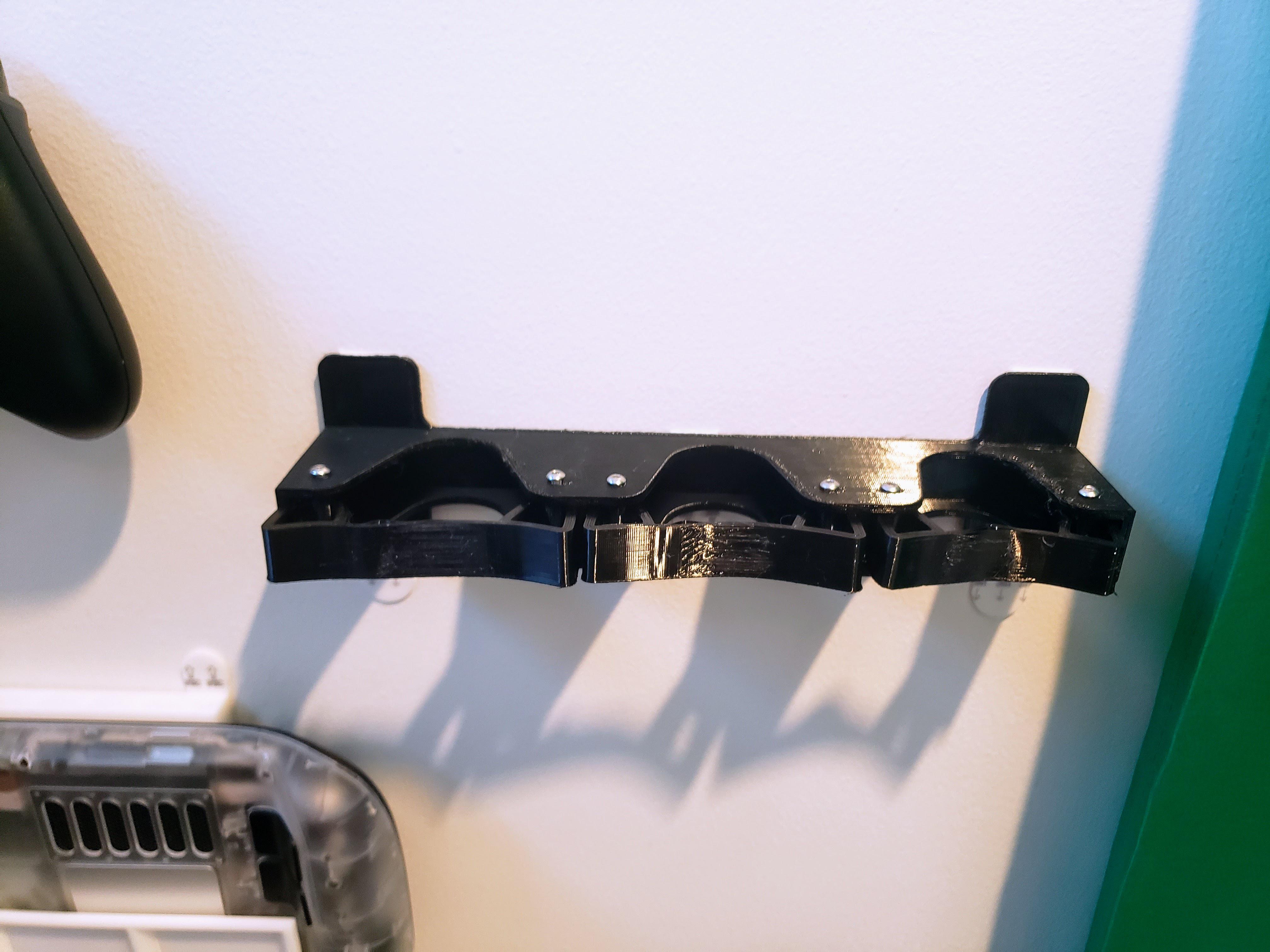 Designed and printed a command-strip mounted holder for my woodwinds, based off of the command ...
