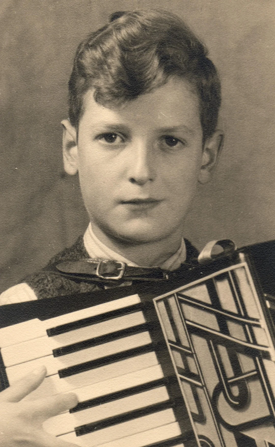 Twelve-year-old dad getting a hang of his accordion, 1948 | Scrolller