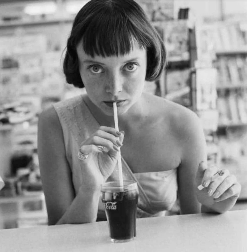A Coke and a smoke for Carolyn Jones and her eyes. ~ 1956 | Scrolller