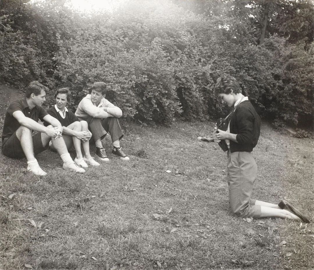 Jackie Kennedy takes a photo of RFK, his wife Ethel, and JFK hanging out at a Georgetown park ...