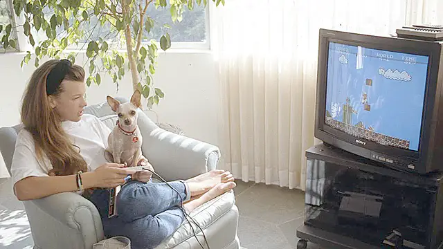 Milla Jovovich enjoying Super Mario Bros. on the Nintendo NES (Early 1990's) | Scrolller