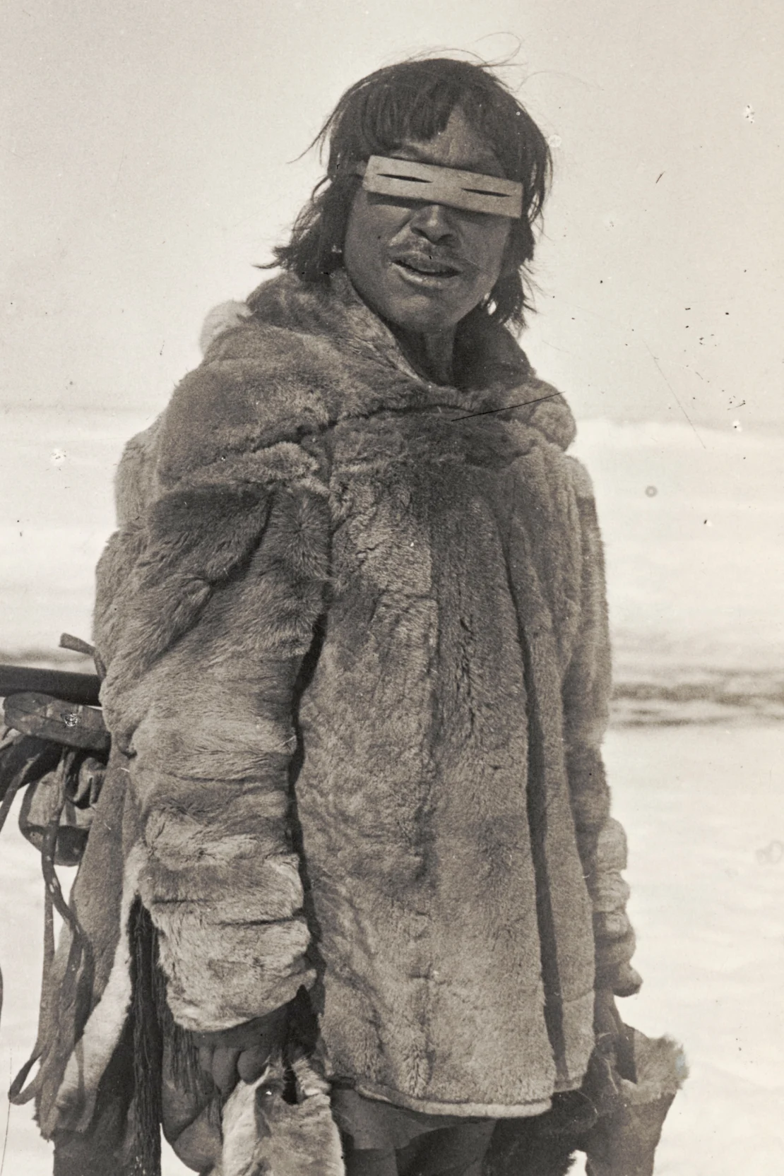 Inuit hunter pictured wearing wooden snow glasses in Canada's Northwest Territories (1921 ...