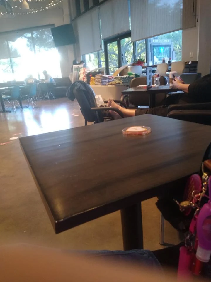 some woman at the coffee shop has her bare feet on a chair at a coffee shop..... | Scrolller