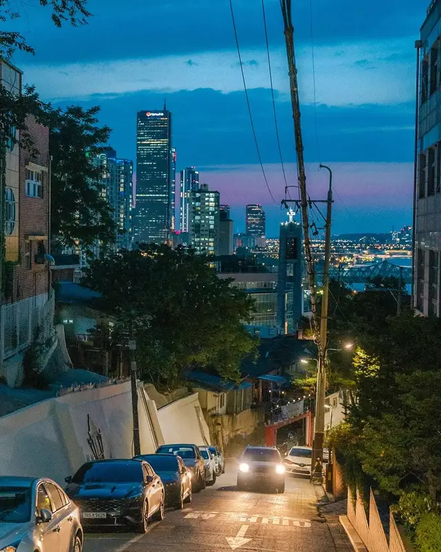 Sloped street with Yeouido skyline views in Seoul, South Korea. | Scrolller