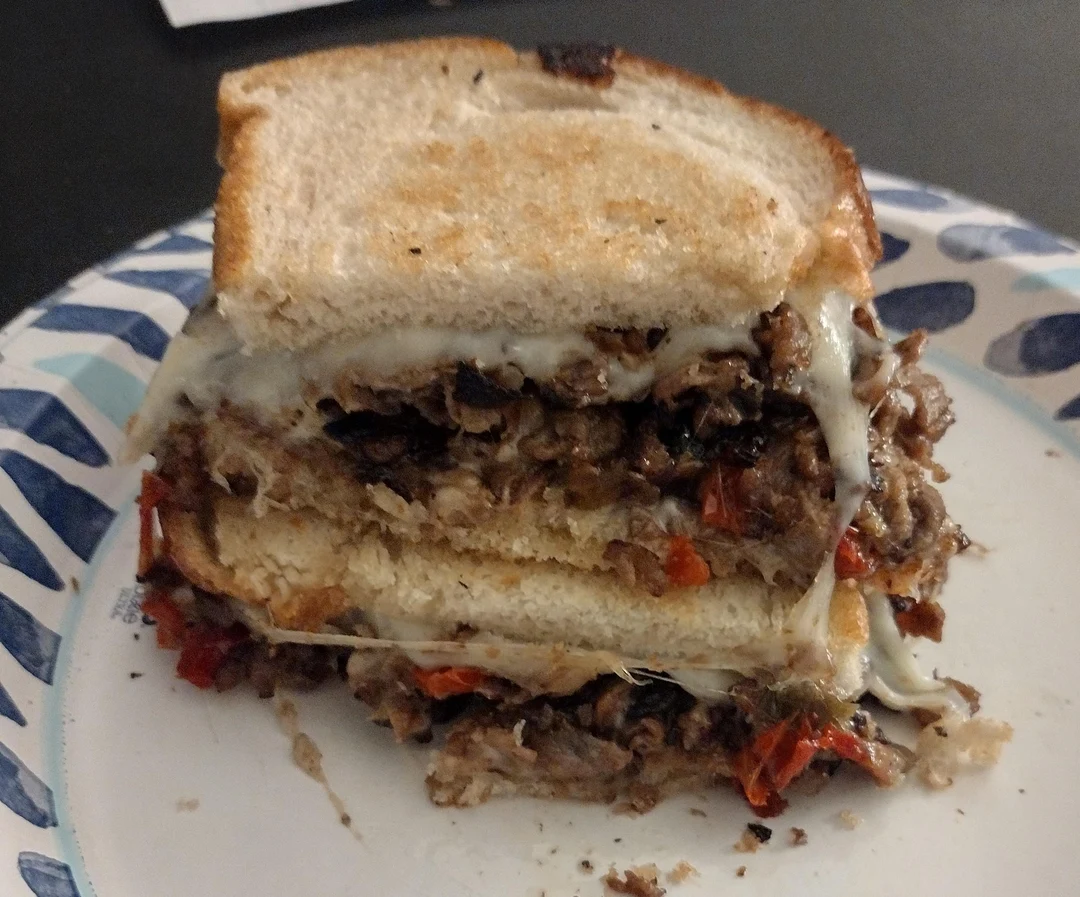 Cheesesteak with Bell Peppers, Onions, and Monterey Cheese on sourdough | Scrolller