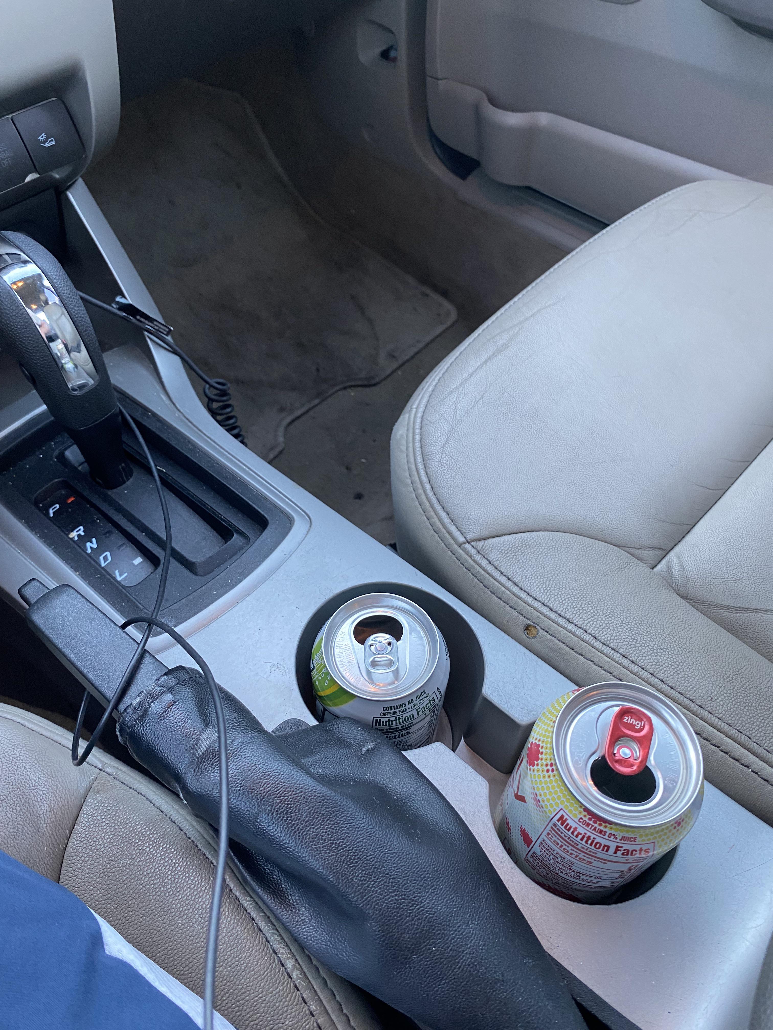 My mom using the only two cup holders in the front seat of our car with ...
