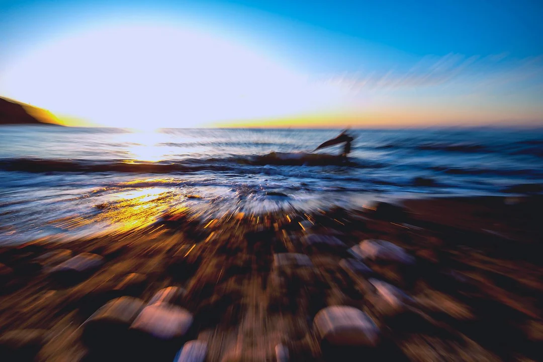 Surfer Under a Sky Dome at Sunset | Scrolller