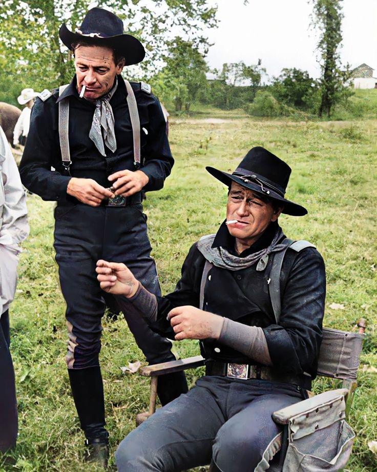 Bill Holden & John Wayne, on the set of 'The Horse Soldiers' | Scrolller