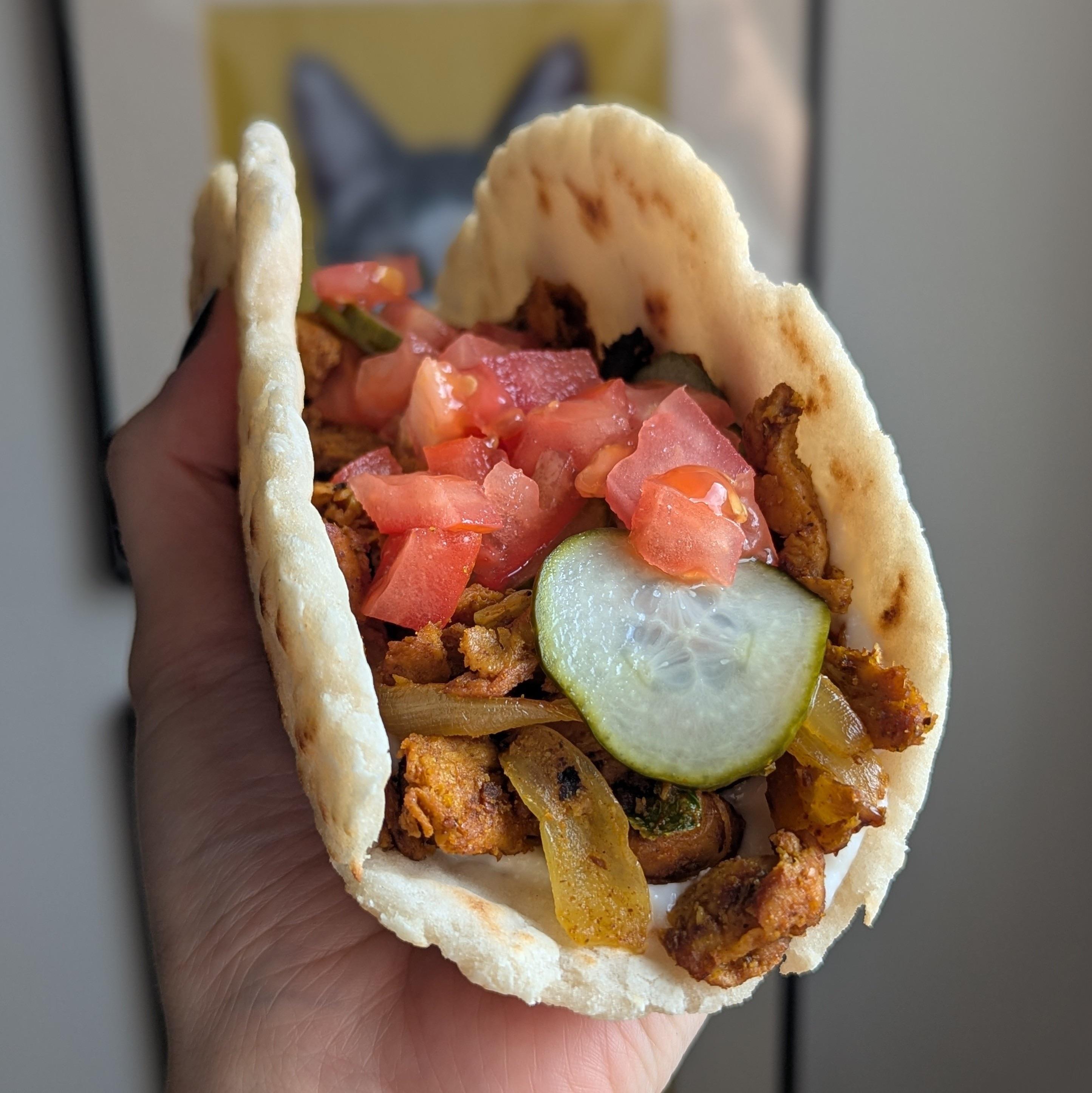 [homemade] chicken shawarma with quickles, garlic sauce, and diced tomatoes on a freshly made ...