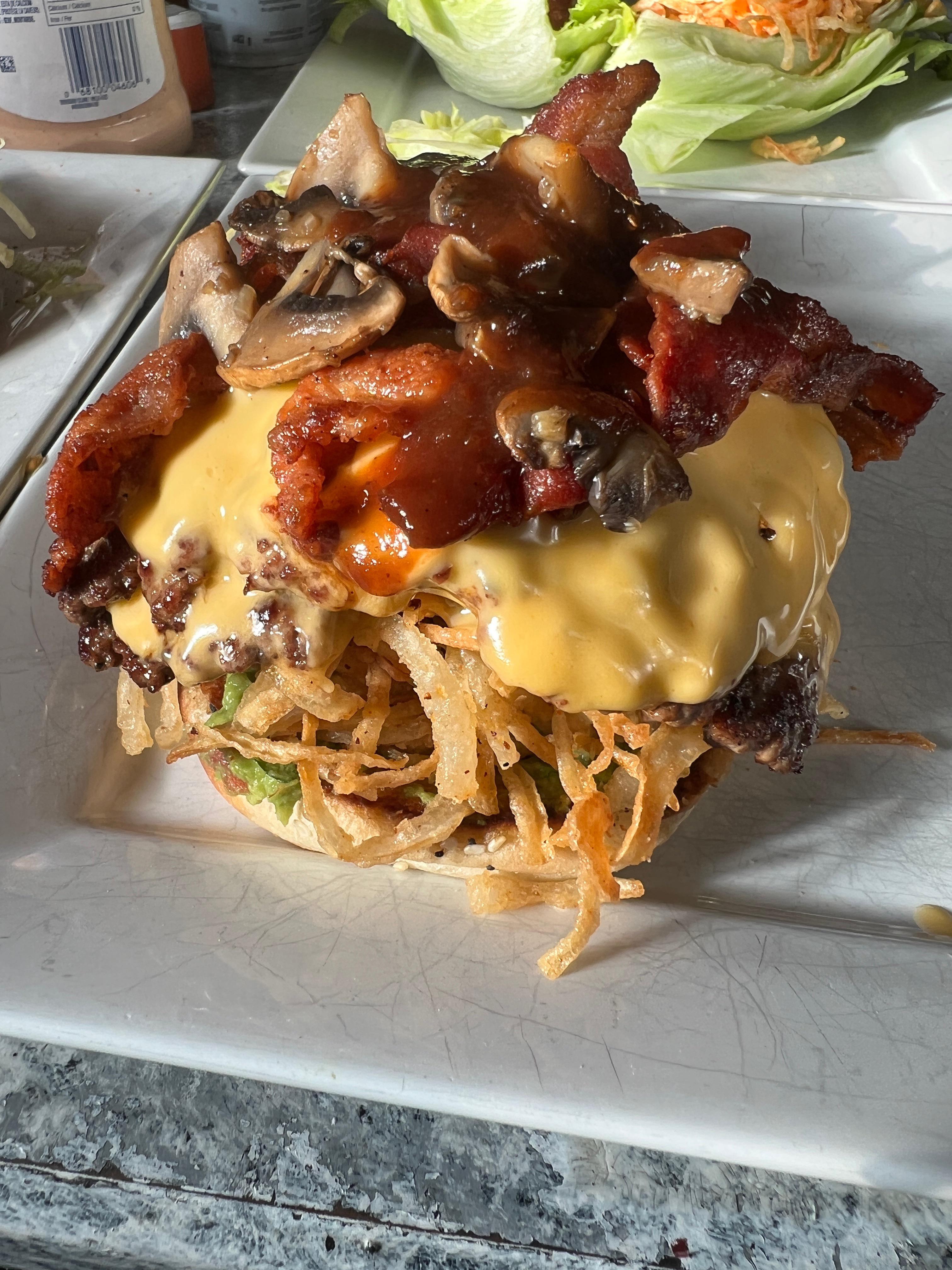 Double smashed bacon cheeseburger with crispy onions. | Scrolller
