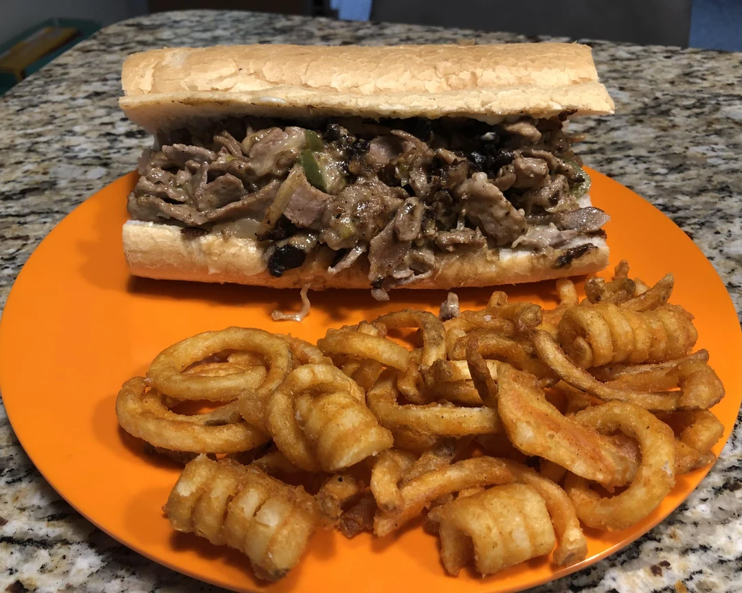 Crispy, shaved pork hoagie and curly fries | Scrolller