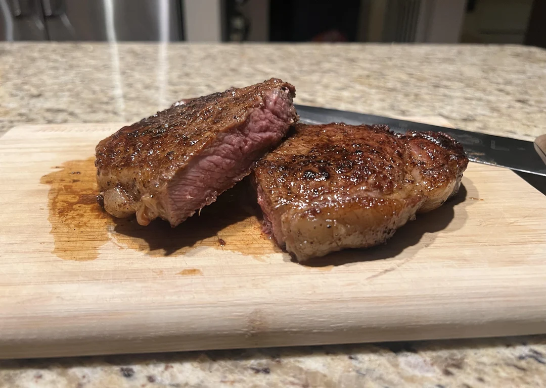 Reverse sear ribeye finished in stainless steel pan. | Scrolller