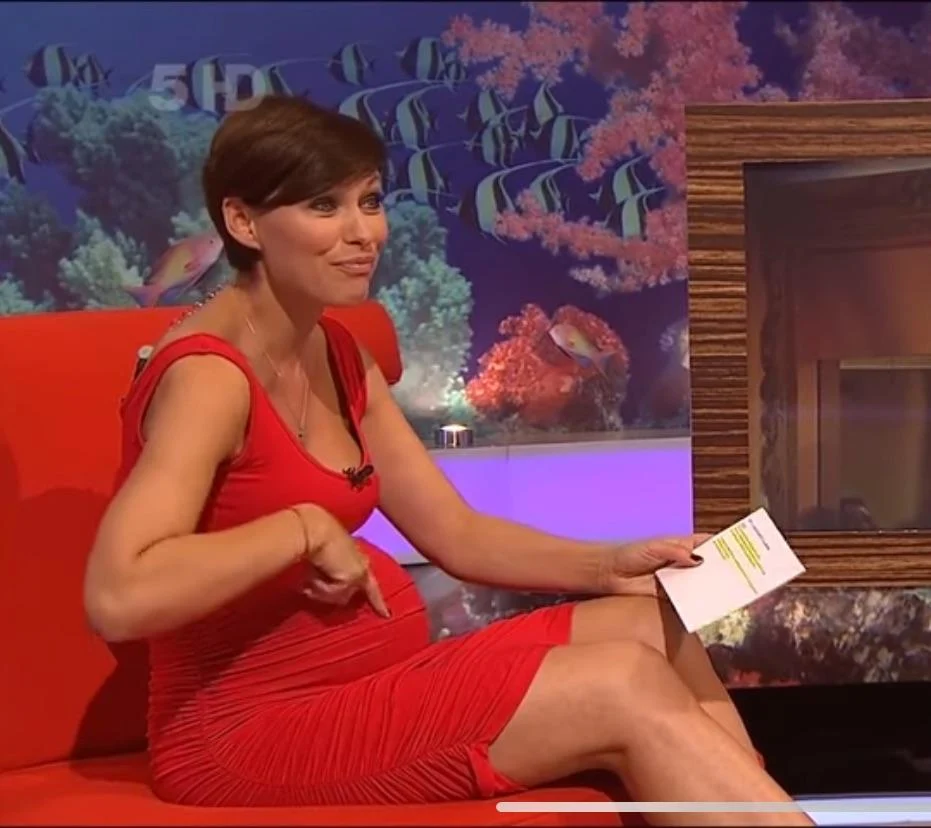 Emma Willis touching her pregnant red bump | Scrolller