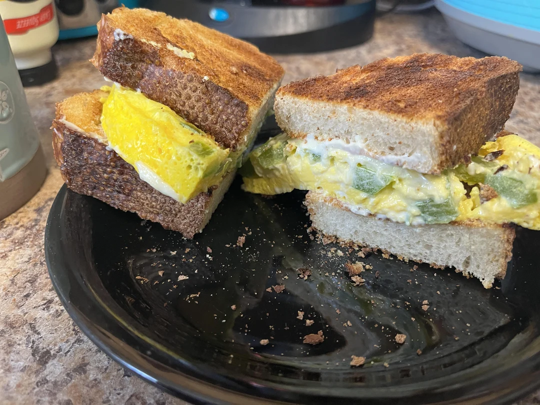 Egg and cheese sandwich with green peppers a medley of shredded cheese’s on sour dough bread ...
