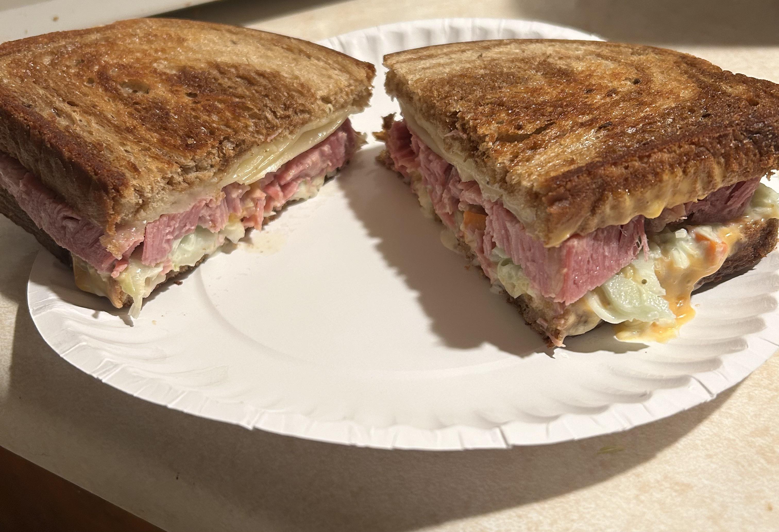 Cooked at home corned beef, swiss cheese, coleslaw, and Russian dressing on a butter marble rye ...