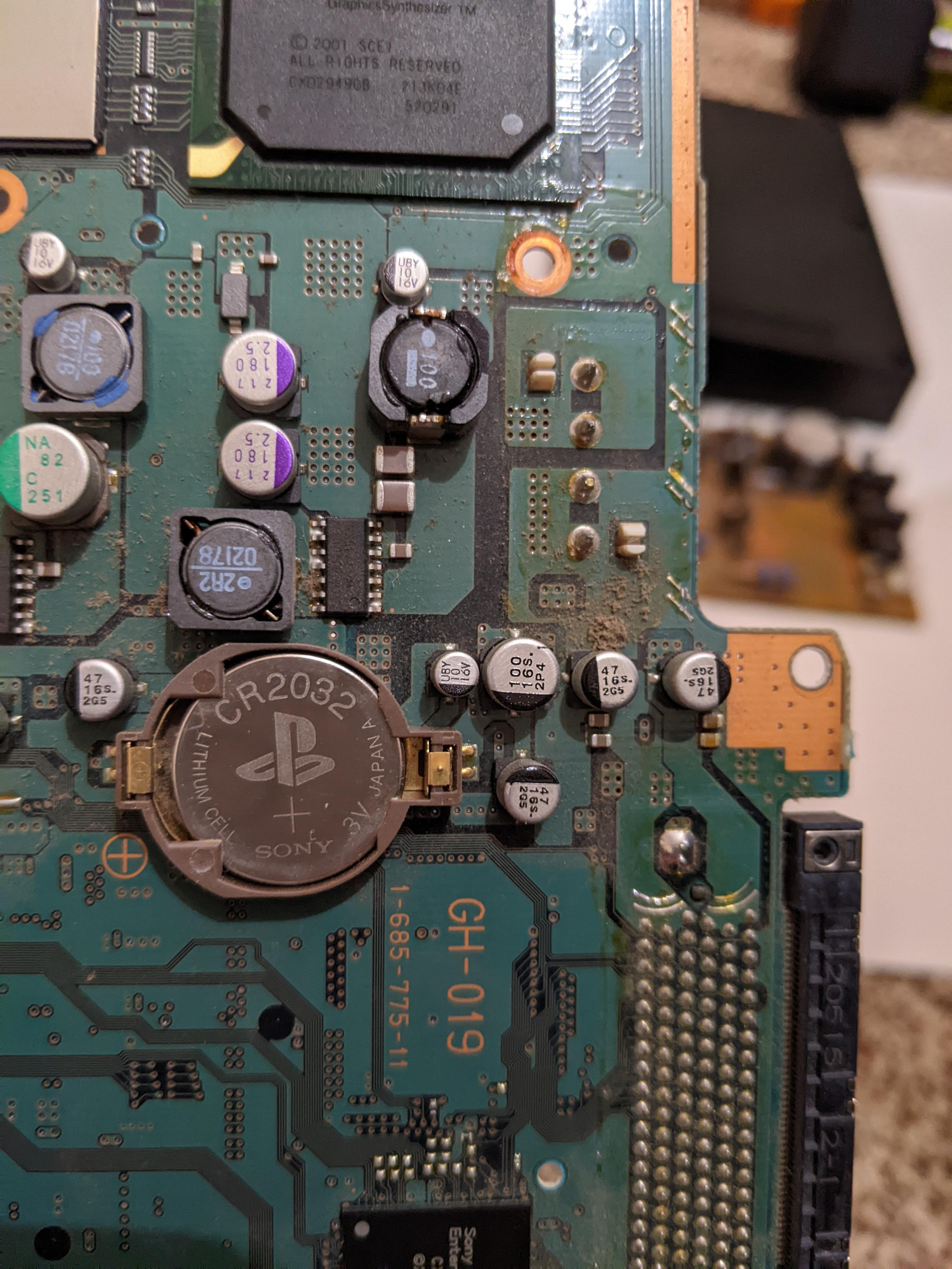 Cleaning out the inside of a PS2, the CMOS battery is stamped with the PlayStation logo | Scrolller