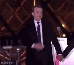 Macron doing a hand gesture during a speech | Scrolller