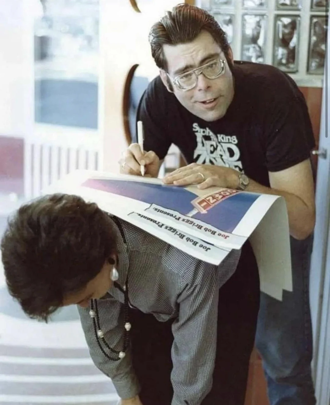 Stephen King signing a poster for a fan 1985 | Scrolller