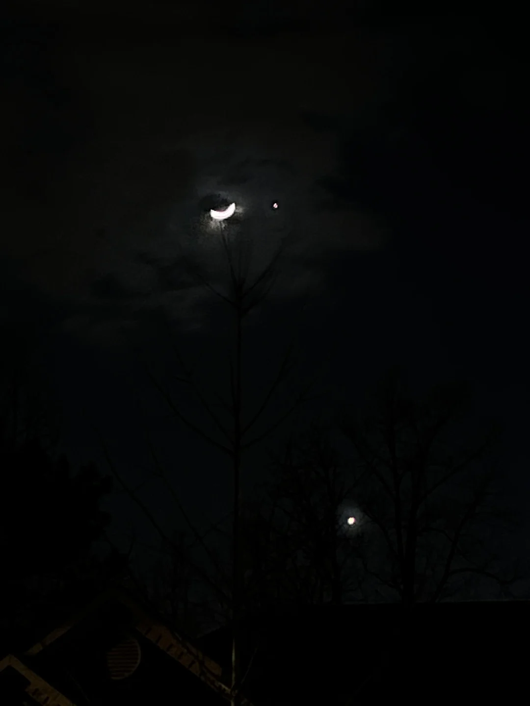 Crescent moon, Venus, and Jupiter under cloudy skies | Scrolller
