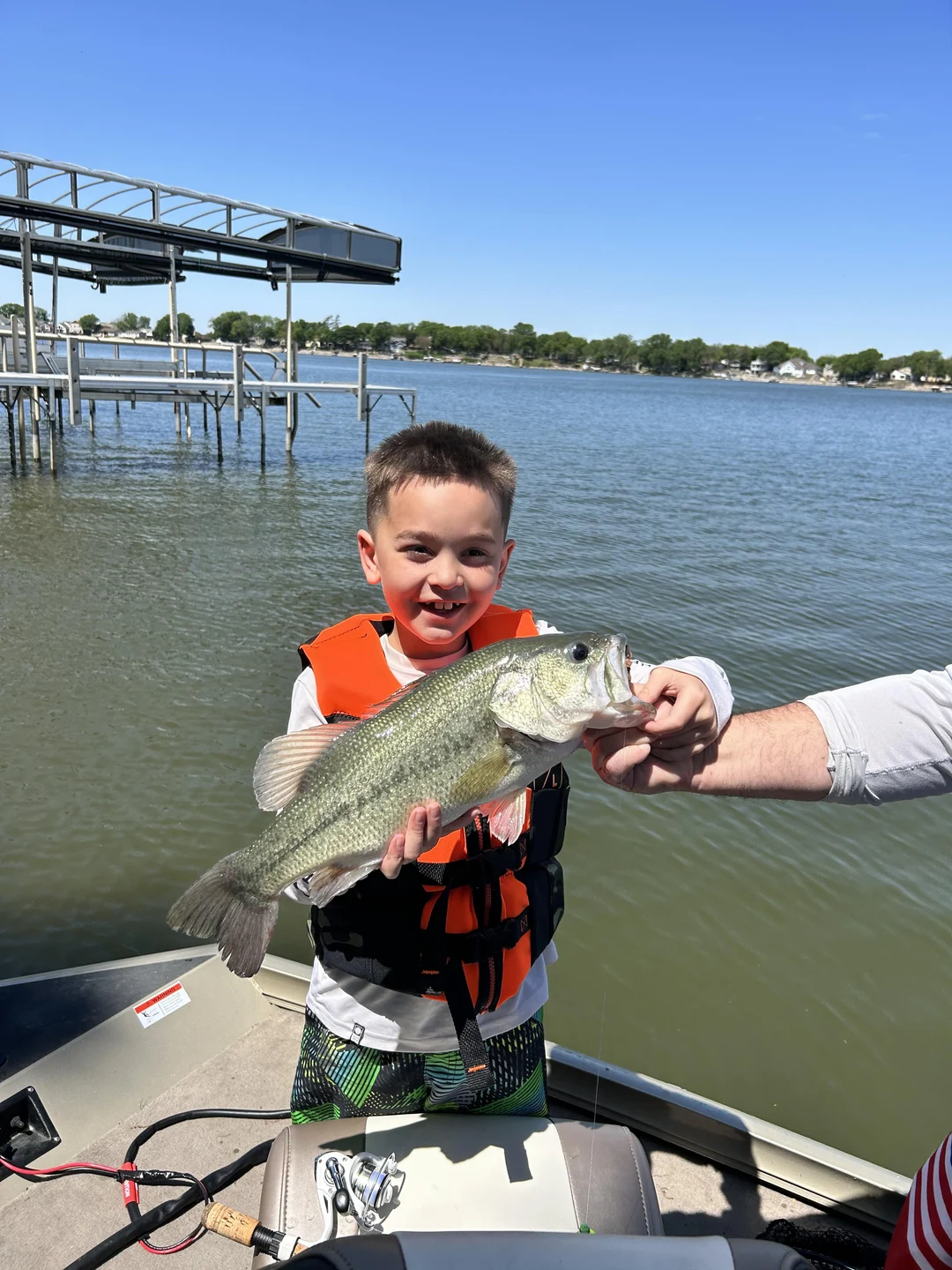 My son is hooked now. He landed this bass on an ultralight fishing with a bobber and worm ...