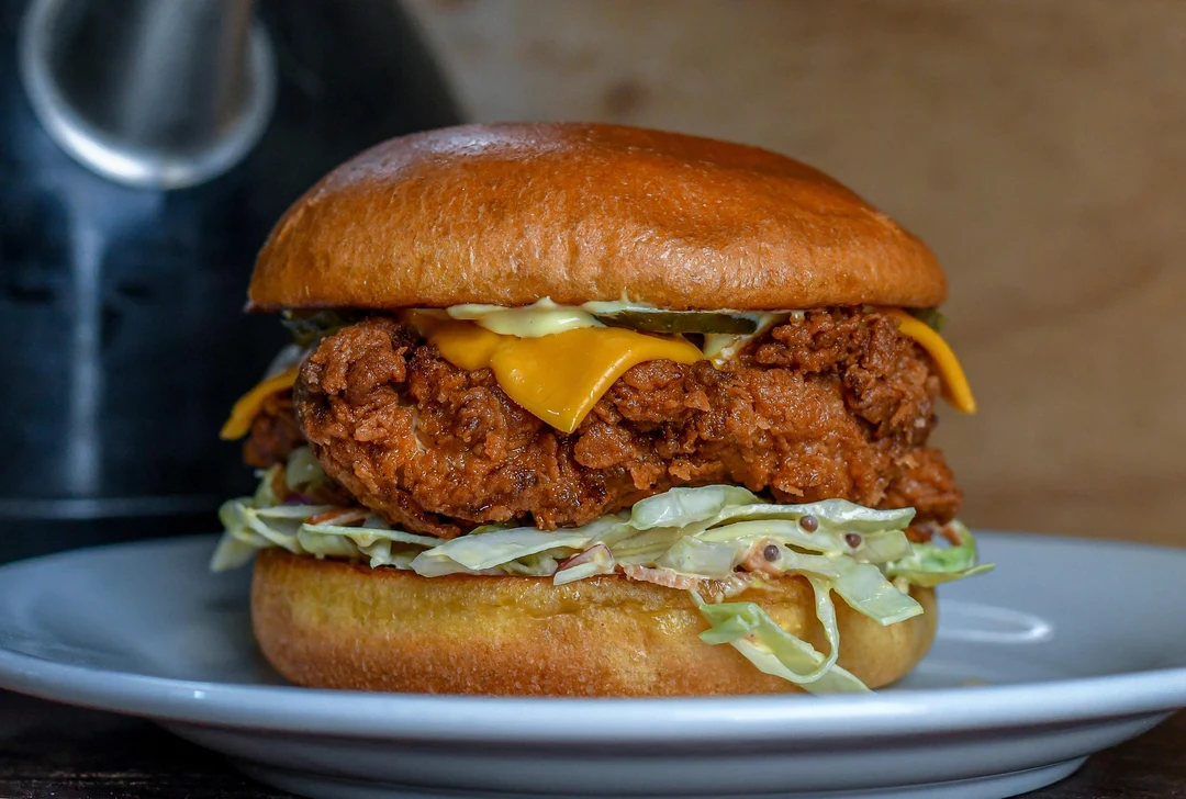 Hot sauce fried chicken with slaw, mustard mayo, pickles and cheese | Scrolller