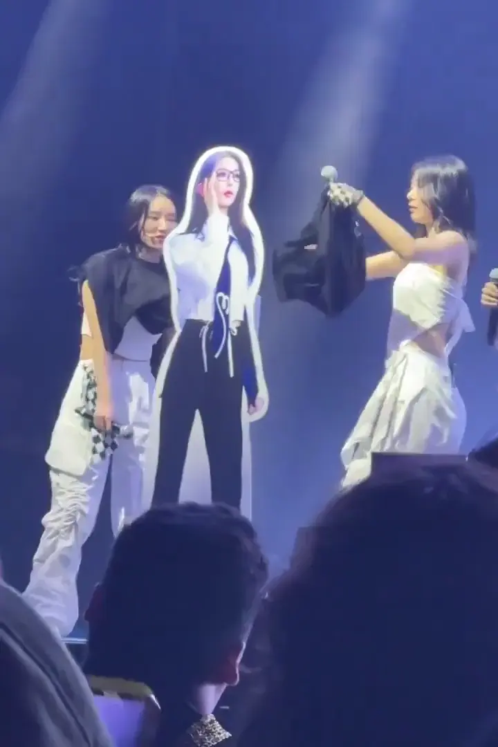Dreamcatcher helping to put the merch T-shirt on Dami | Scrolller