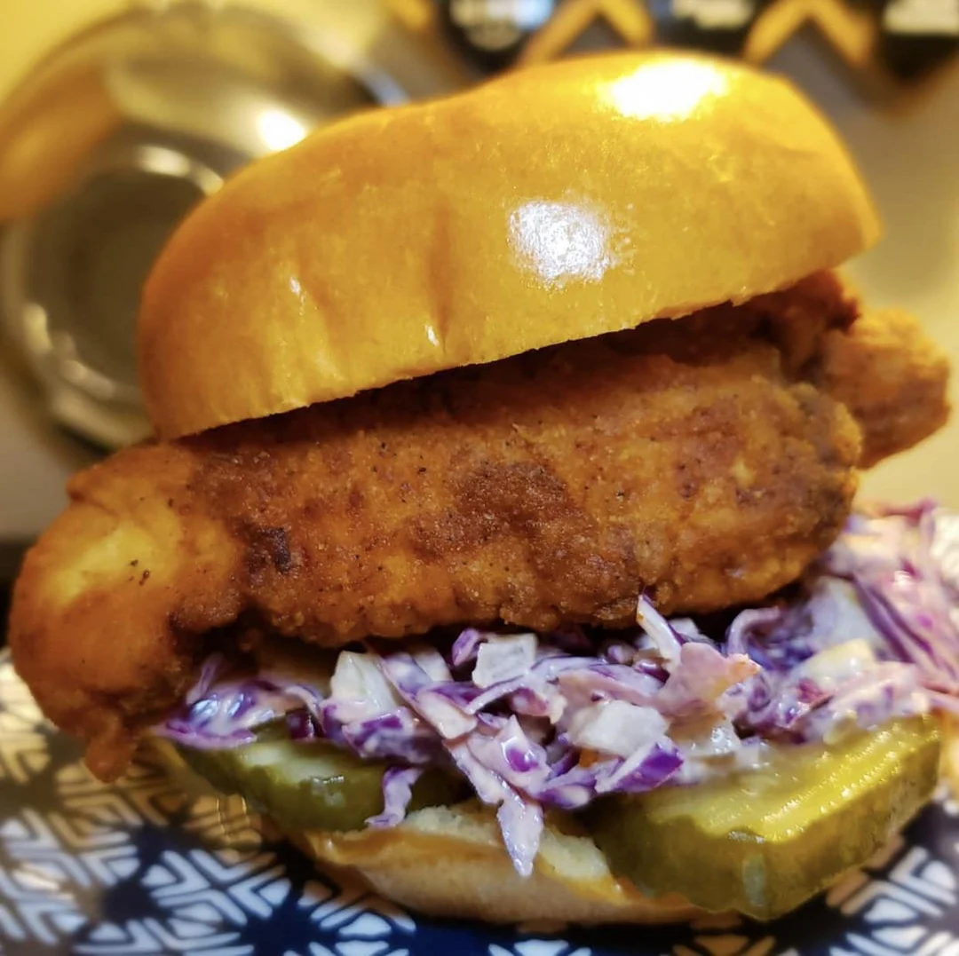 Spicy chicken sandwich with sweet pickles and red cabbage slaw on a brioche bun | Scrolller