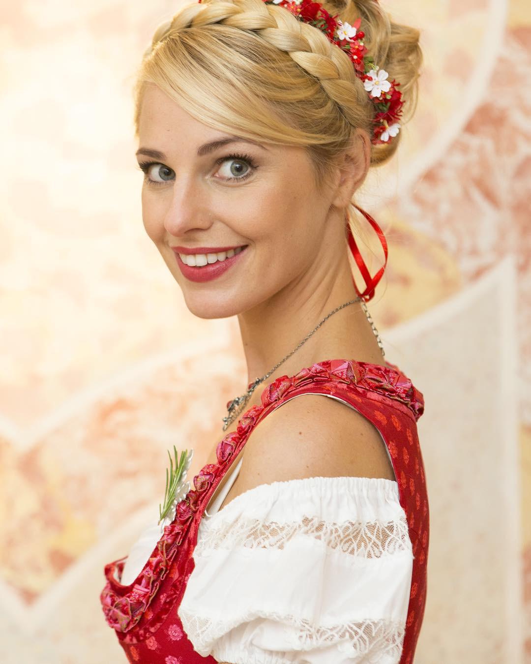 Silvia Schneider red dirndl with flower crown | Scrolller