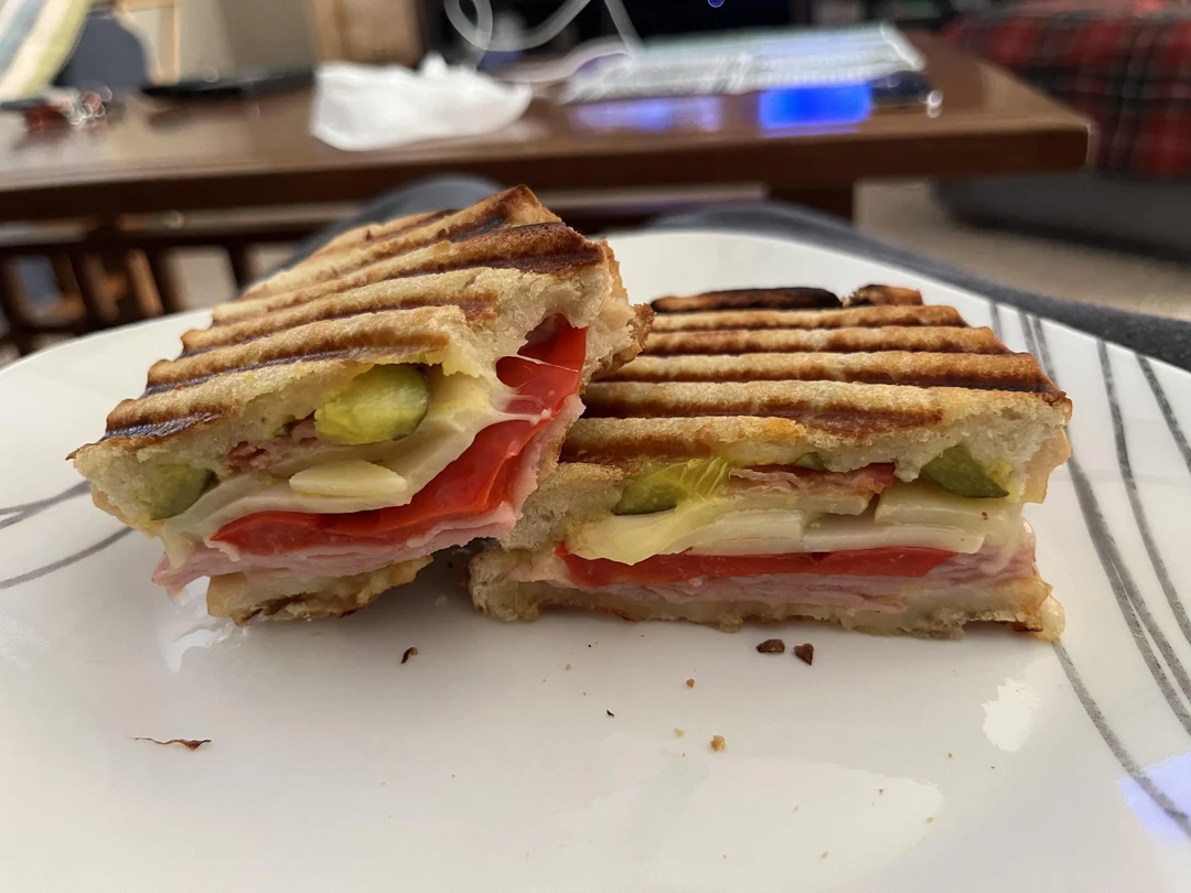 Modified Cubano panini with Swiss cheese, roasted red pepper, and bacon | Scrolller