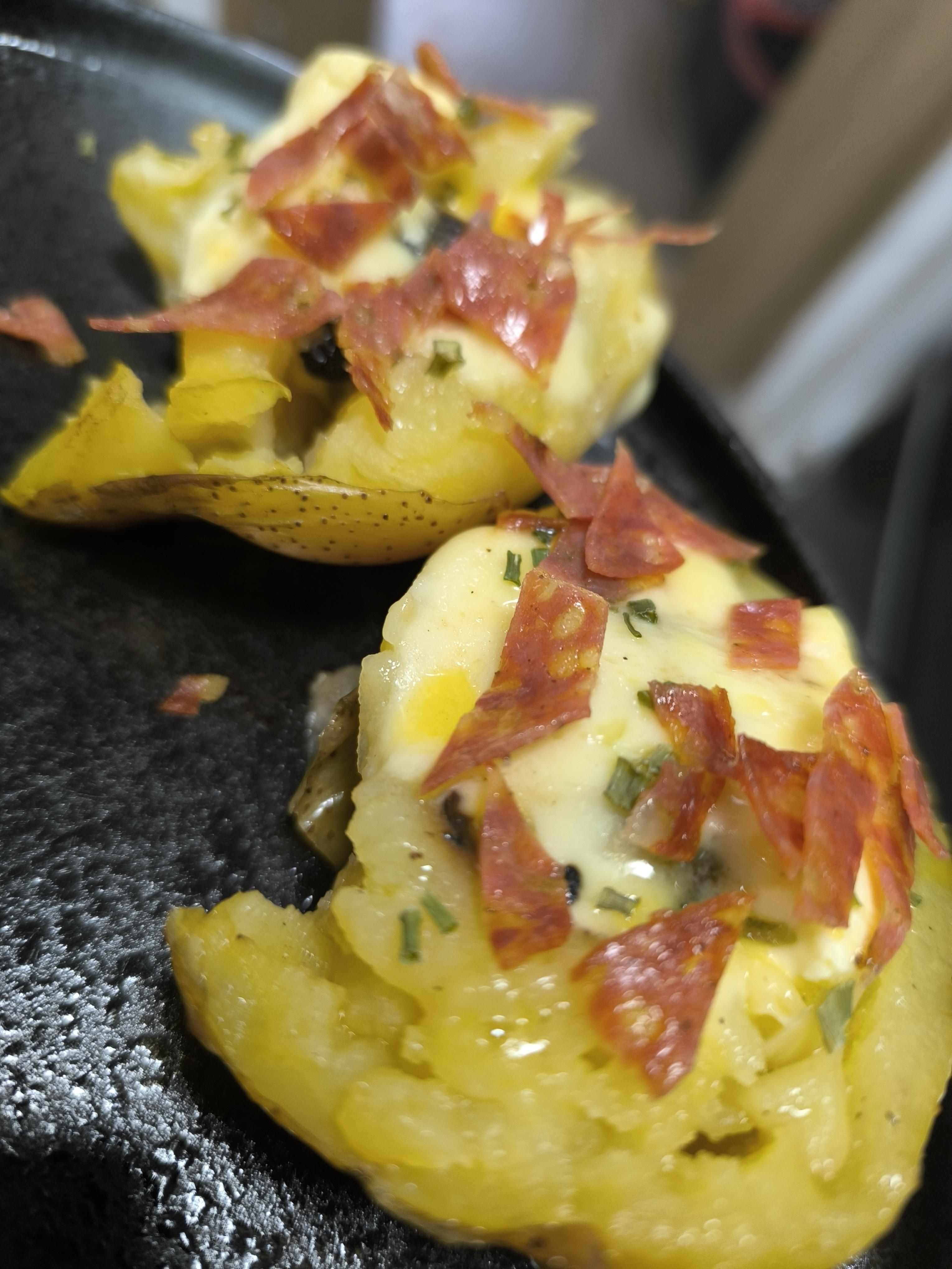 Perfect med-rare steak with a side of baked potatoes. | Scrolller