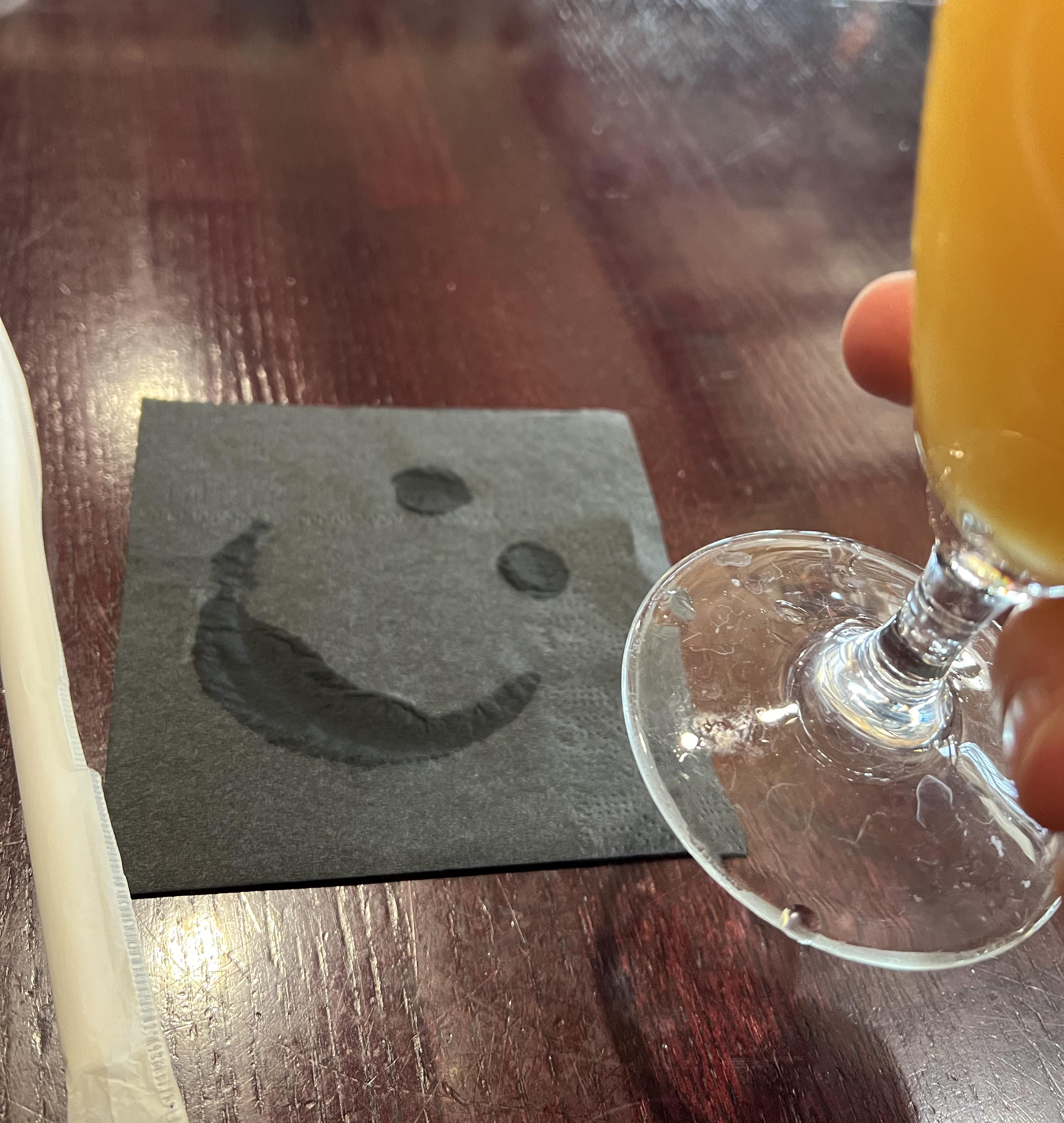 Glass condensation made a smiley face on the napkin | Scrolller