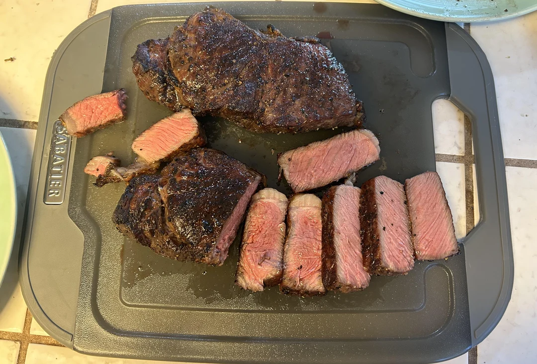 First steaks on a charcoal grill | Scrolller