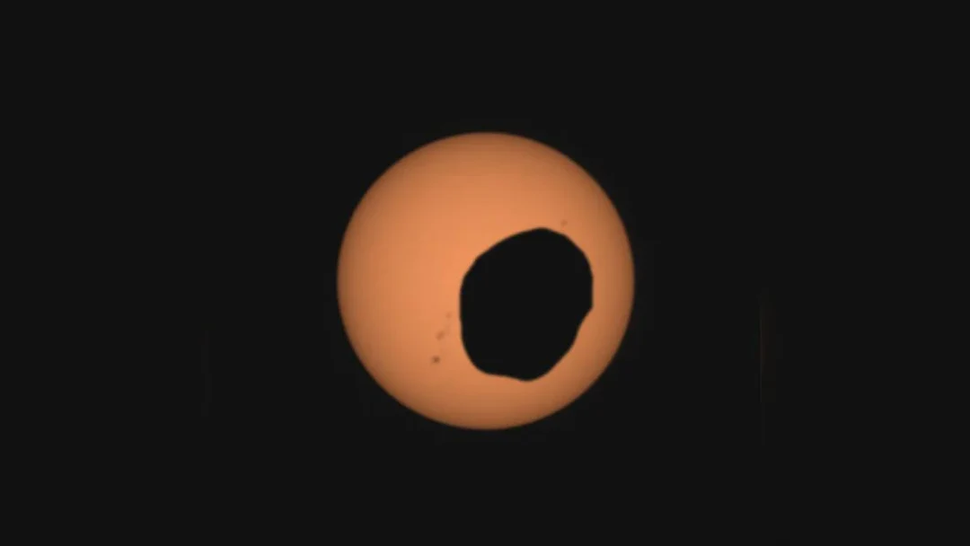 A Martian solar eclipse, captured by the Perseverance rover, as Phobos passes between Mars and ...