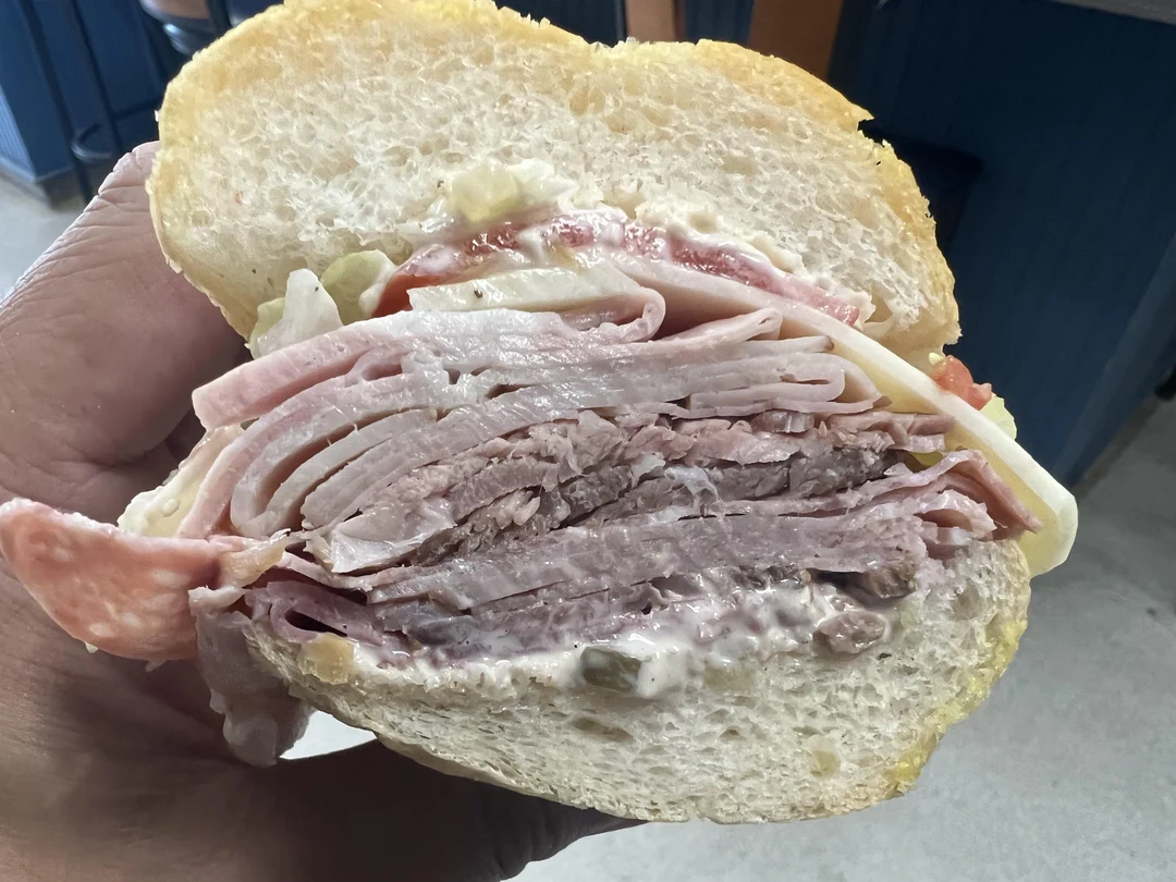 Turkey, pastrami, roast beef, ham, mortadella, salami, provolone, lettuce, tomato, onion, and ...