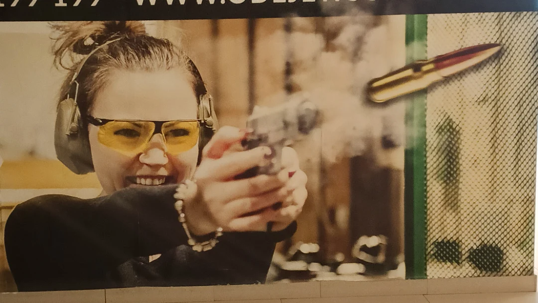 This shooting range ad that shows a gun firing a cartridge. | Scrolller