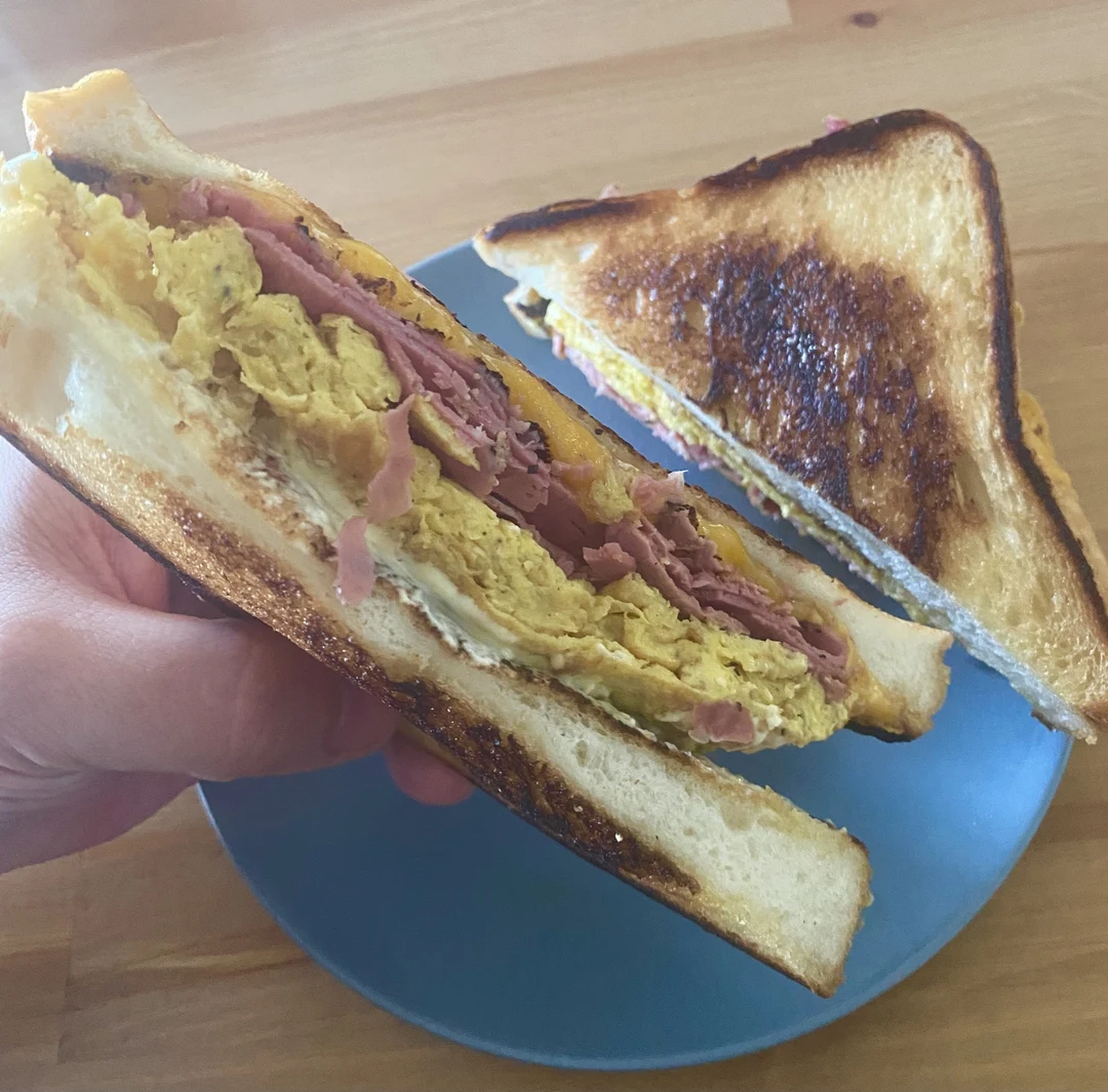 Pastrami and cheddar breakfast sandwich on milk bread with homemade mayo and Valentina hot sauce ...