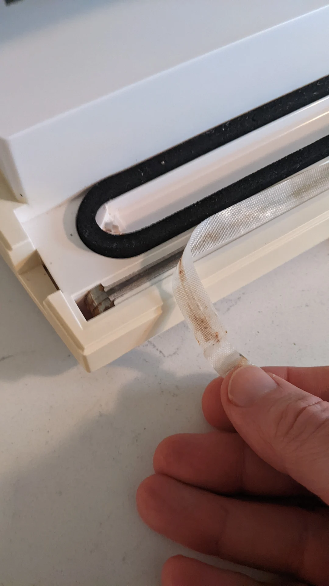 My bag sealer has this part that has come loose. Should I just hot glue it back in place ...